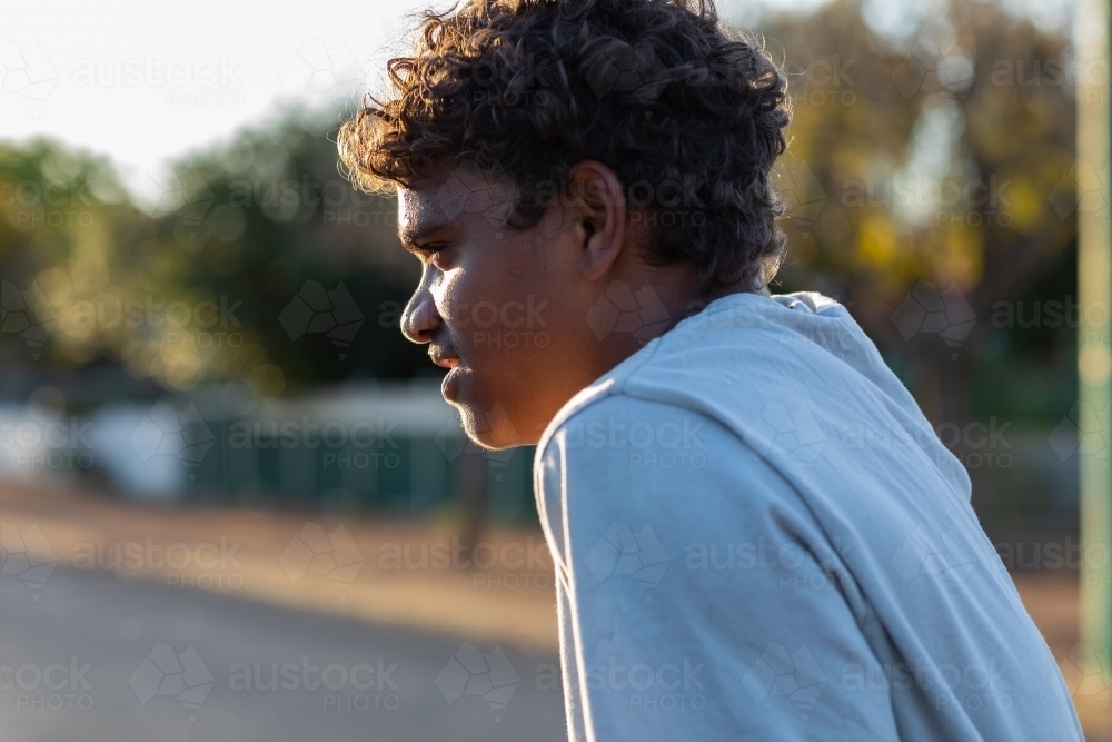 Image of head and shoulders of aboriginal boy in profile - Austockphoto