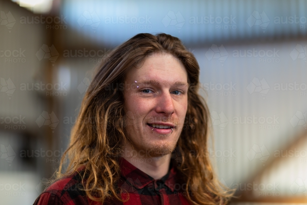 Image of head and shoulders young man inside the shed smiling ...