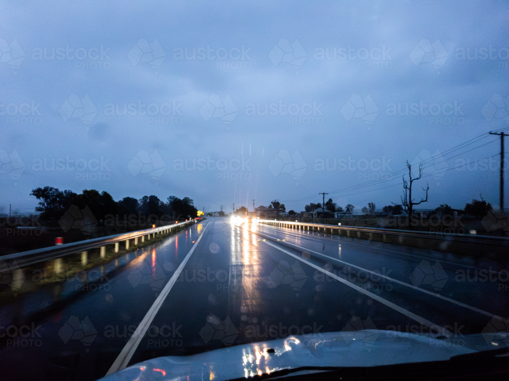 Image of Headlights of cars approaching on highway at night on rainy ...