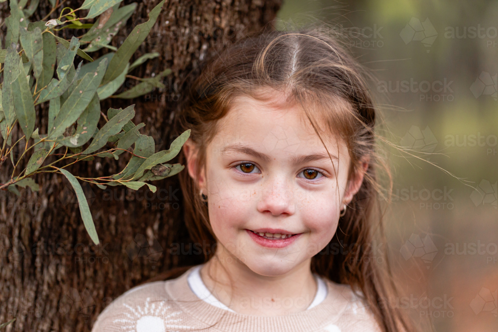 Image of Headshot of aboriginal child smiling in bushland with gum ...
