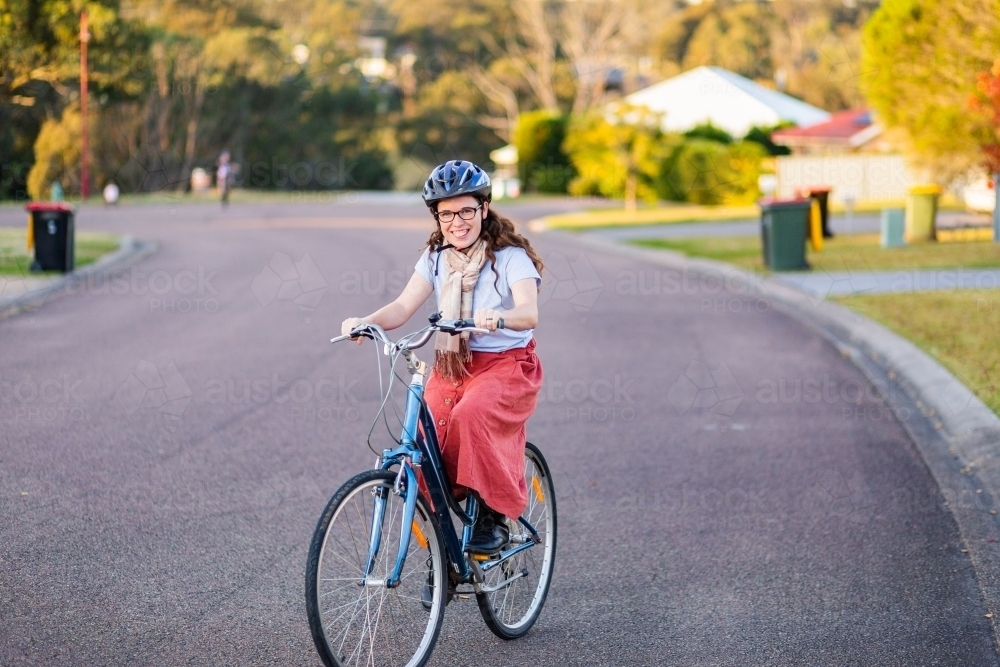 Image of Healthy young australian person exercising by riding her push ...