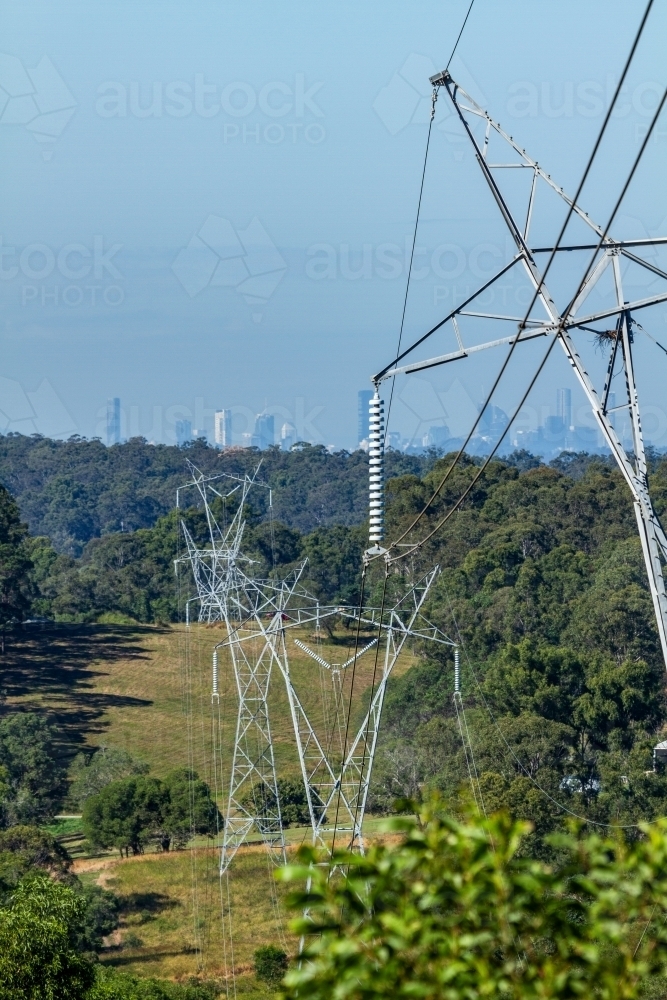 Image of High voltage electricity power lines and power poles with Brisbane City CBD in ...