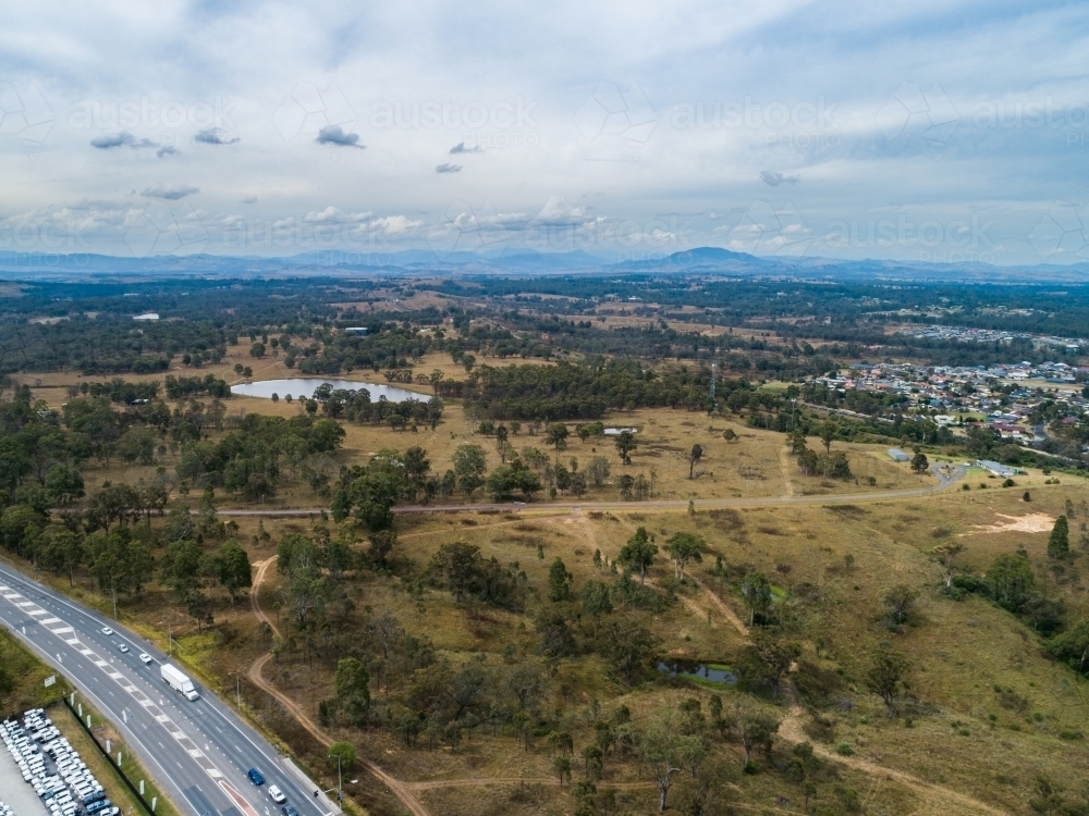 Image of highway with paddock between edge of town as sound buffer ...