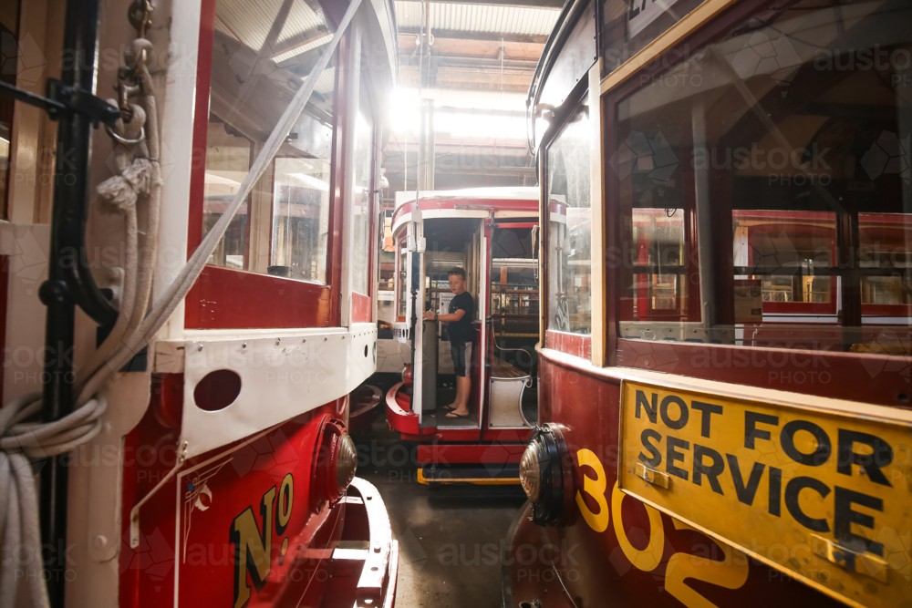 Image of Historic red trams in depot, sunlight highlighting vintage ...