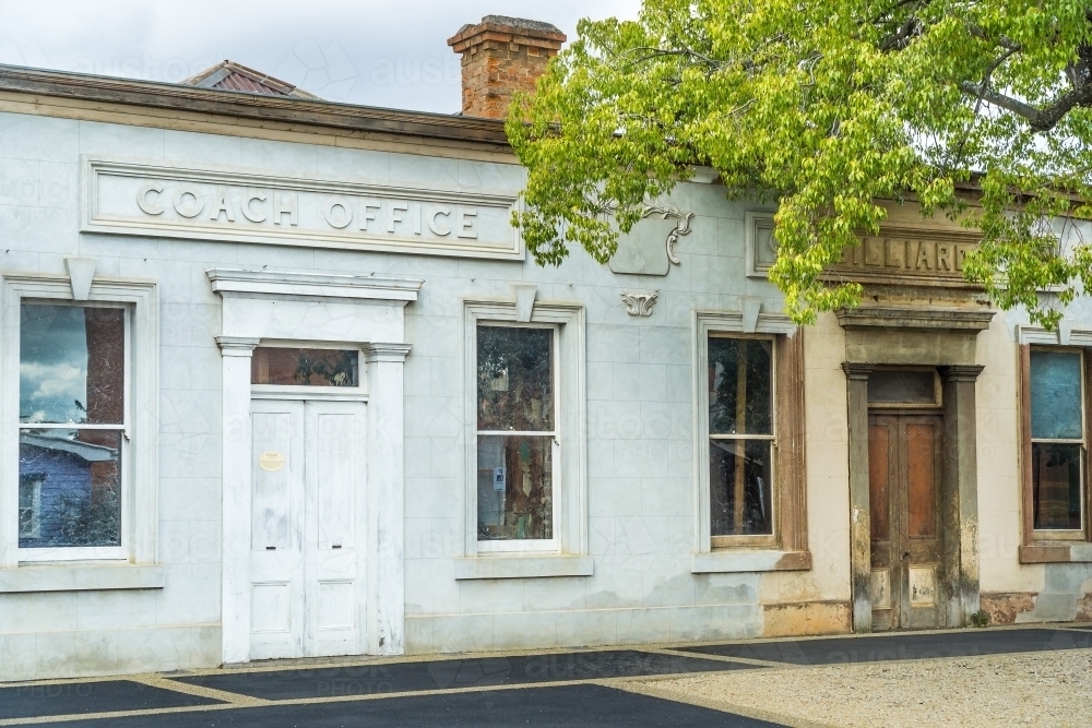 Image of Historic shop fronts along a footpath - Austockphoto