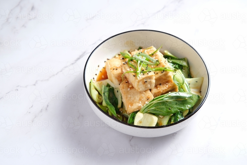 Image of Hoisin tofu pho garnished with black sesame seeds. - Austockphoto