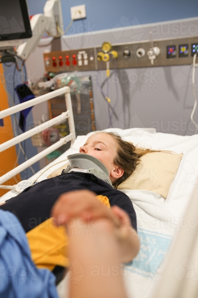 Image of Holding hand of a young girl in hospital wearing a neck brace ...