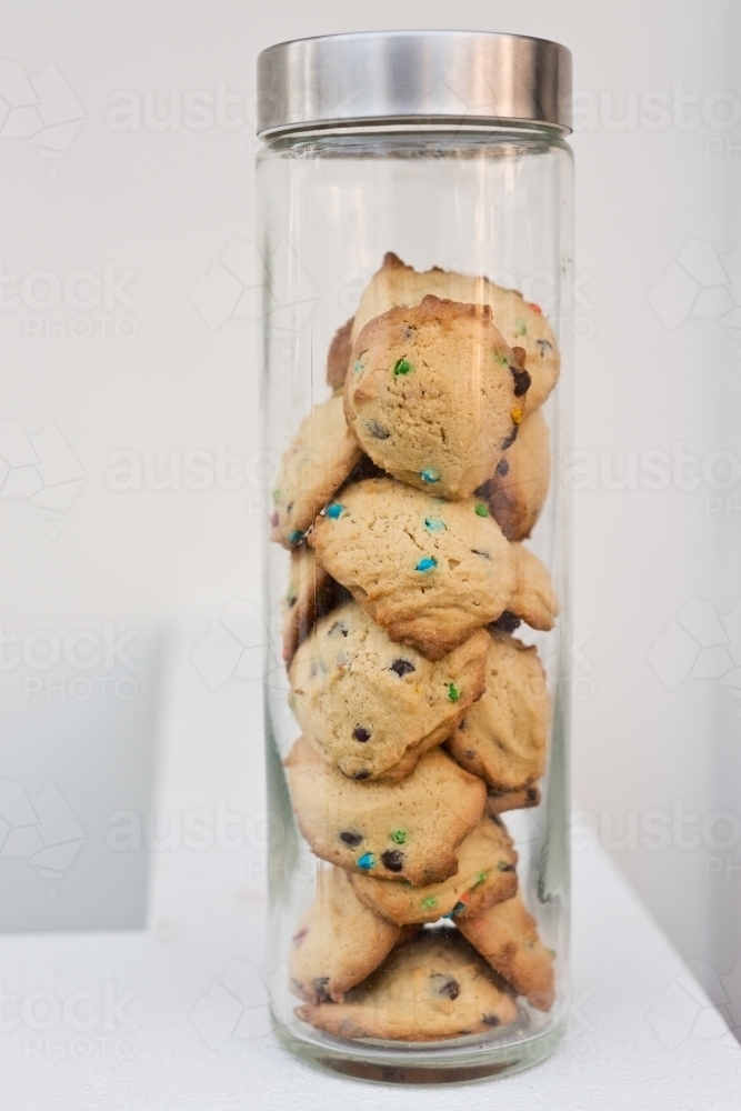 Image of homemade cookies in a tall glass jar - Austockphoto