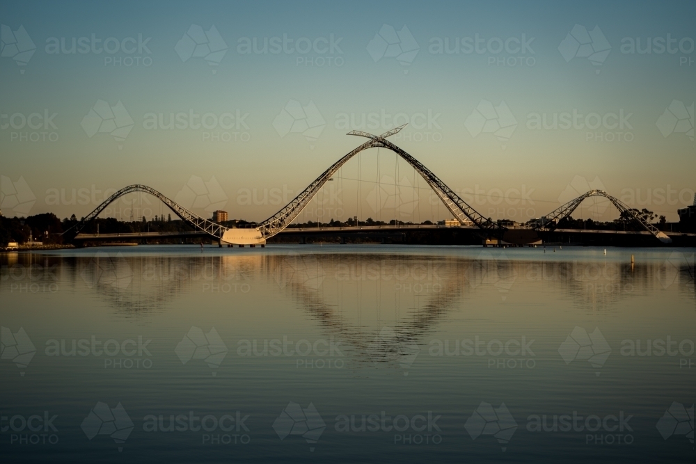 Image of horizontal shot of a bridge with wavy structures reflecting in ...