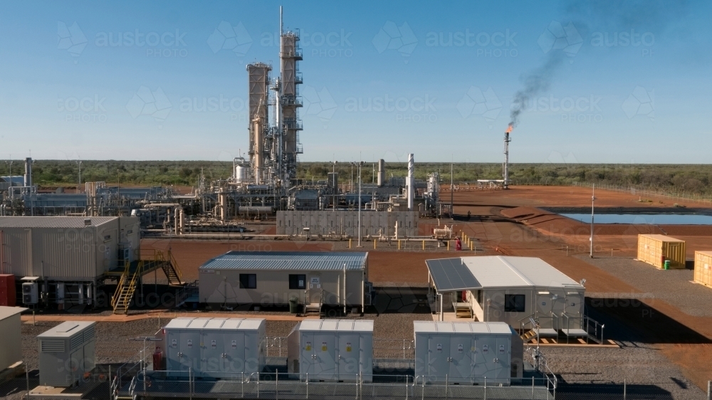 Image of Horizontal shot of a power plant with a smoking flue-gas stack ...