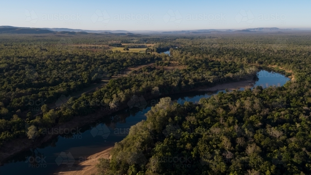 Image of Aerial view of river surrounded by bushland - Austockphoto