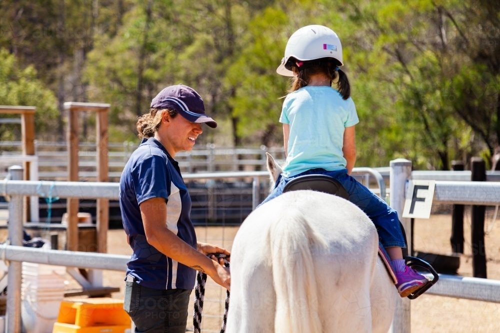 Image of Horse riding instructor giving lesson to student on horseback ...