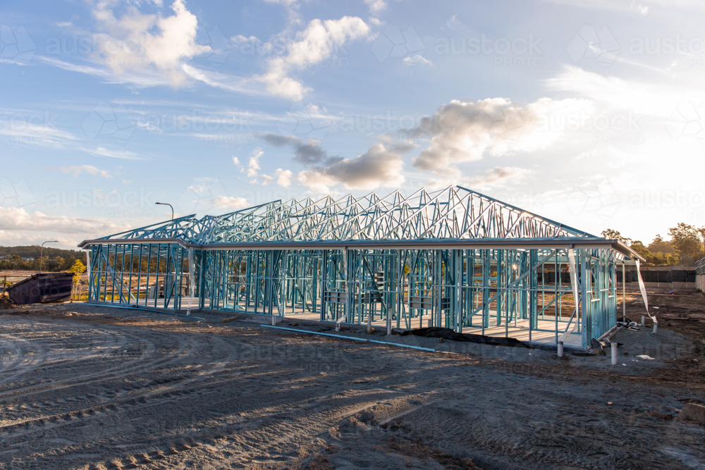 Image of house being built with metal frame in afternoon light ...