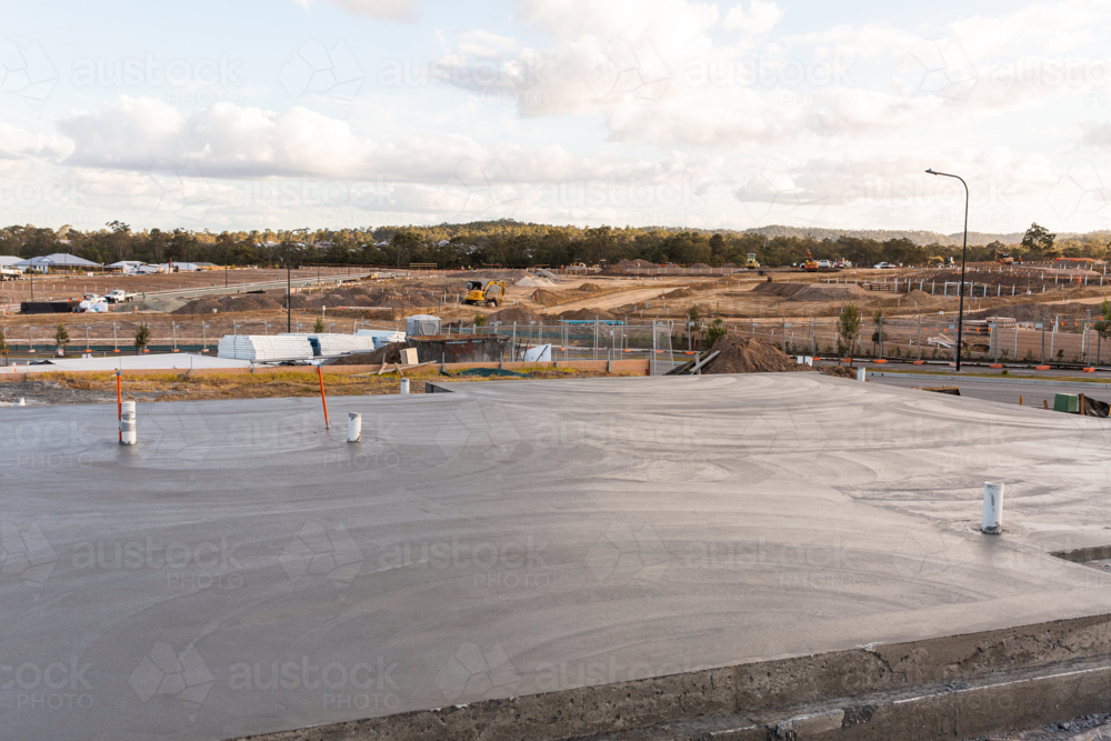 Image of house slab at a new estate with earthworks in the distance ...