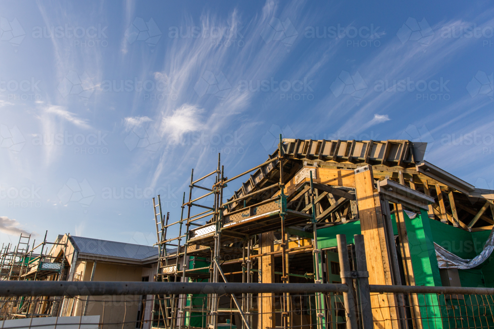 Image of houses getting built on a new estate with a temporary fence ...
