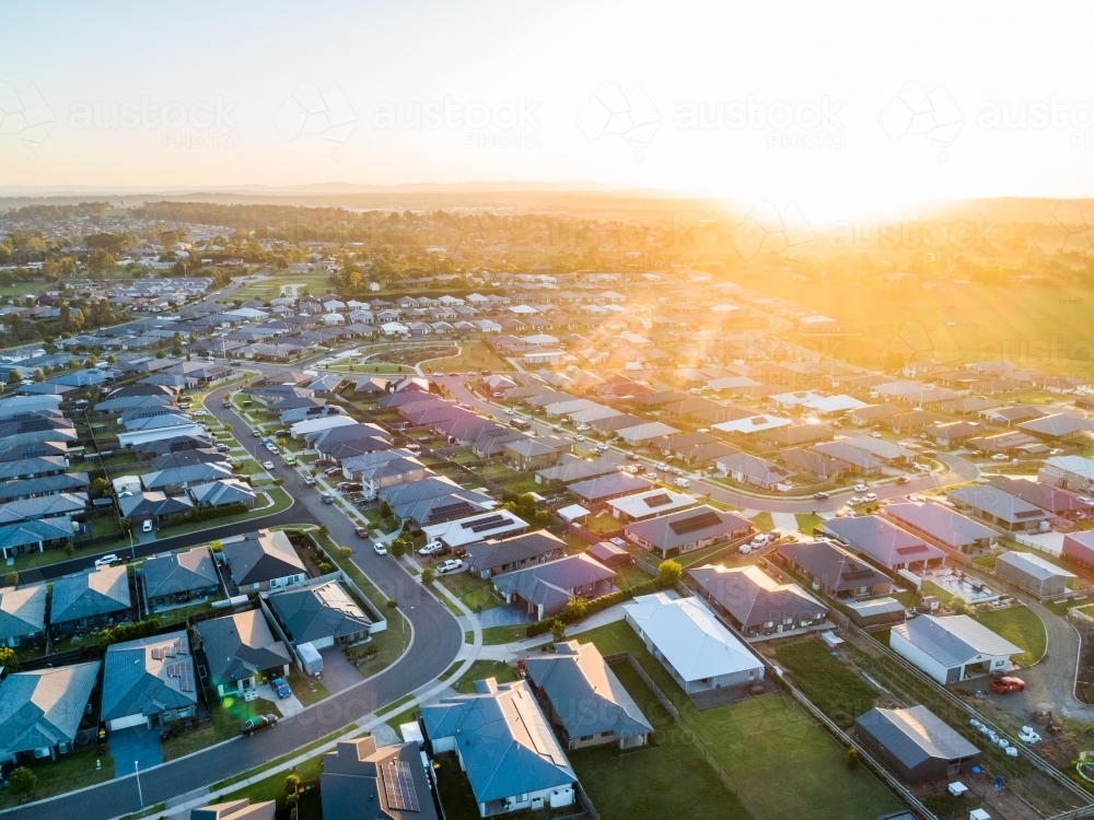 Image of Housing affordability – Aerial view of sunlight over streets ...