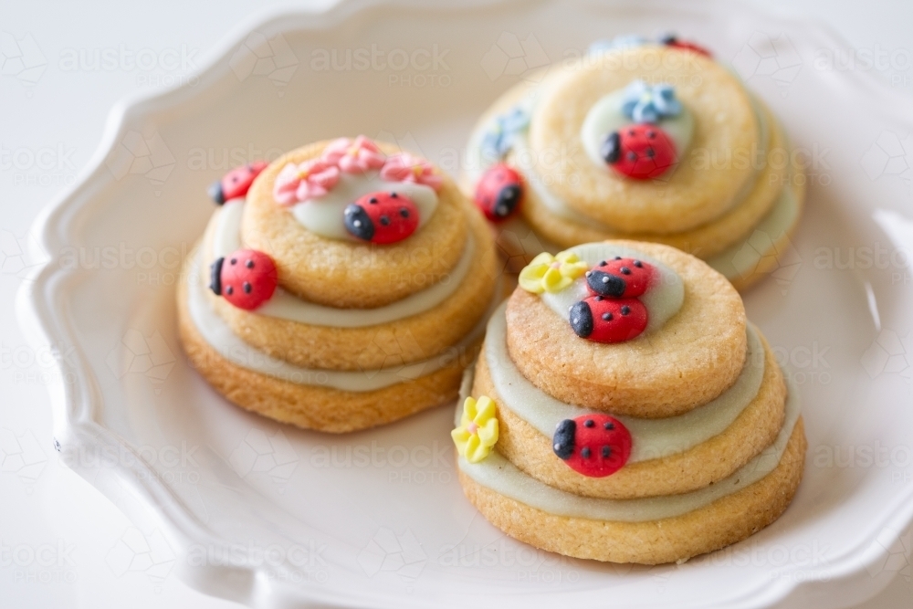 Image of Icing sugar ladybugs on stacked biscuit birthday party treats ...