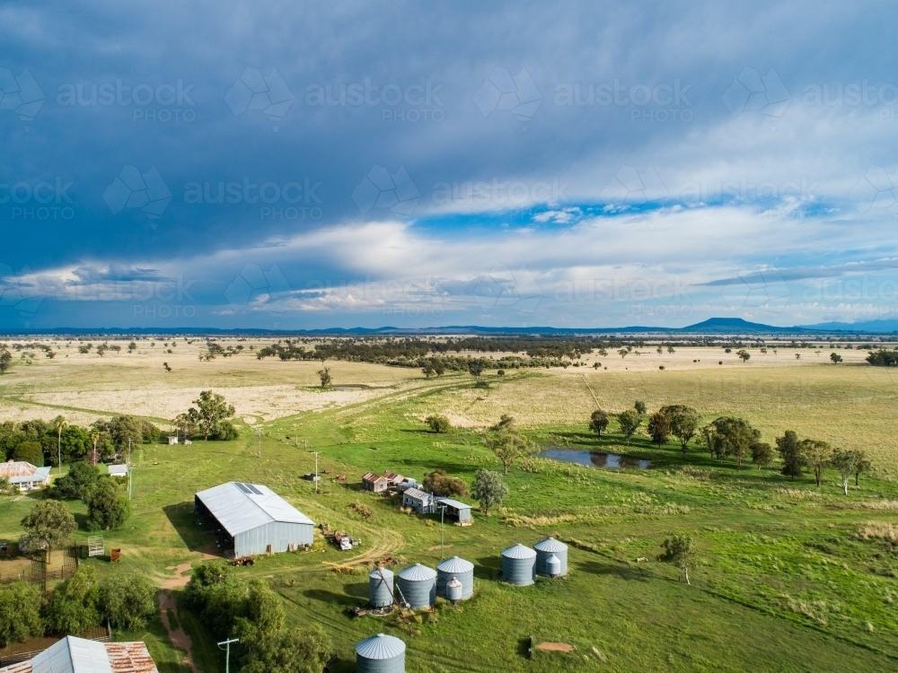 Image of Incoming rain storm over farm with outbuildings and dam in ...