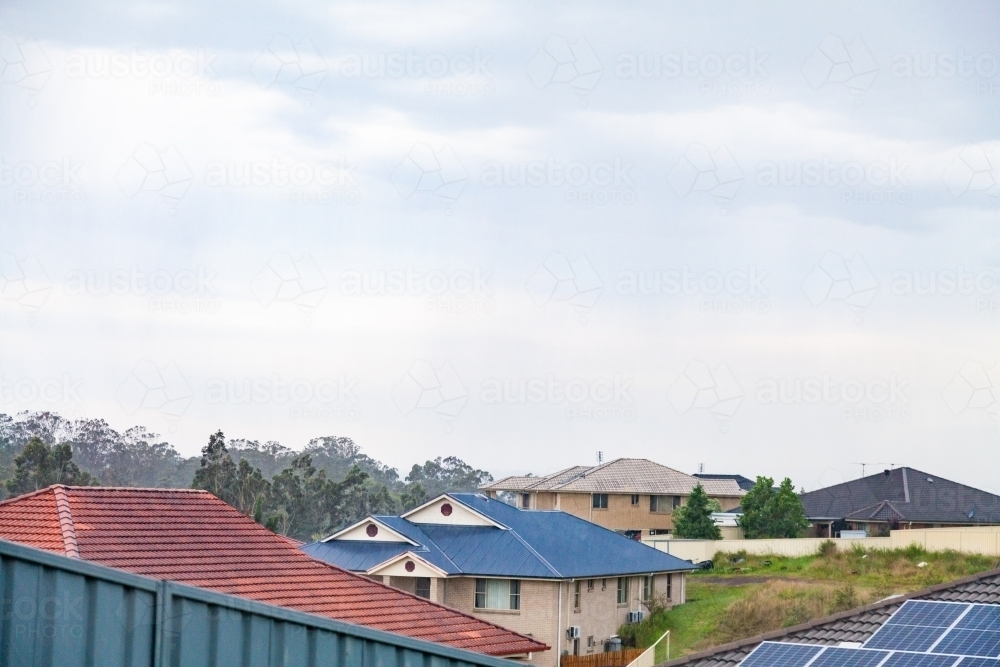Image of Incoming rain storm over rooftops in town - Austockphoto