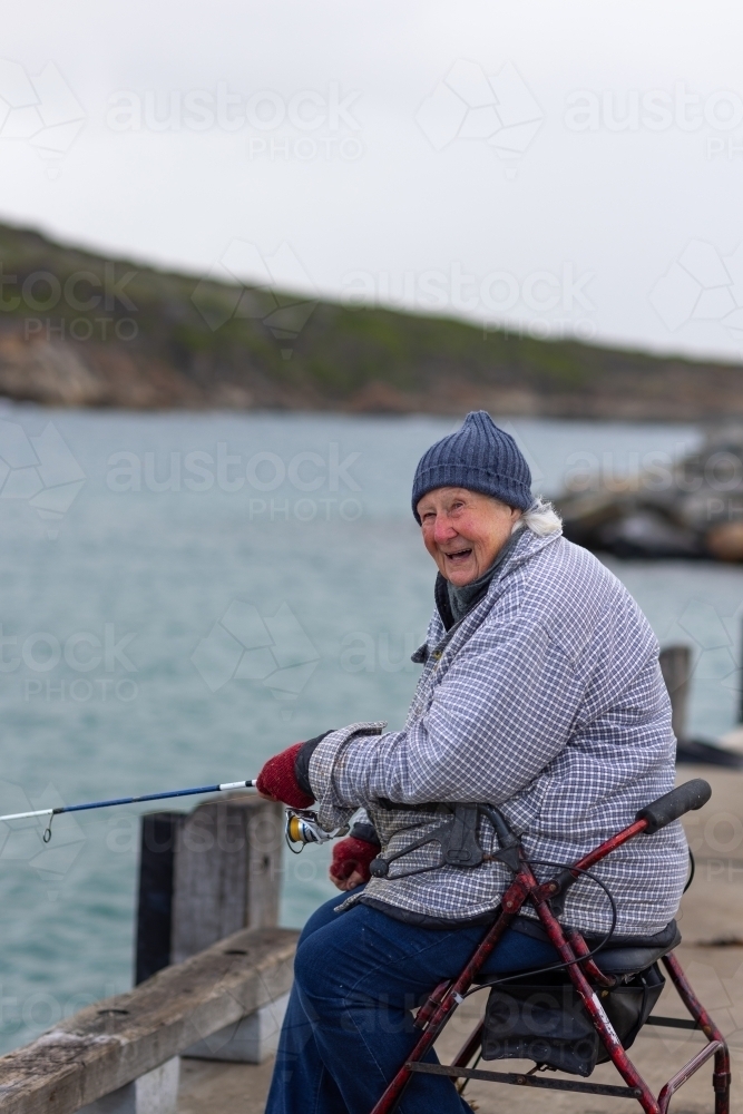 Image of independent elderly lady sitting on wheely walker fishing ...