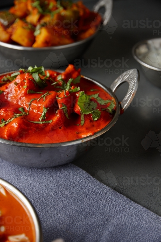 Image of Indian curry dishes on grey table - Austockphoto