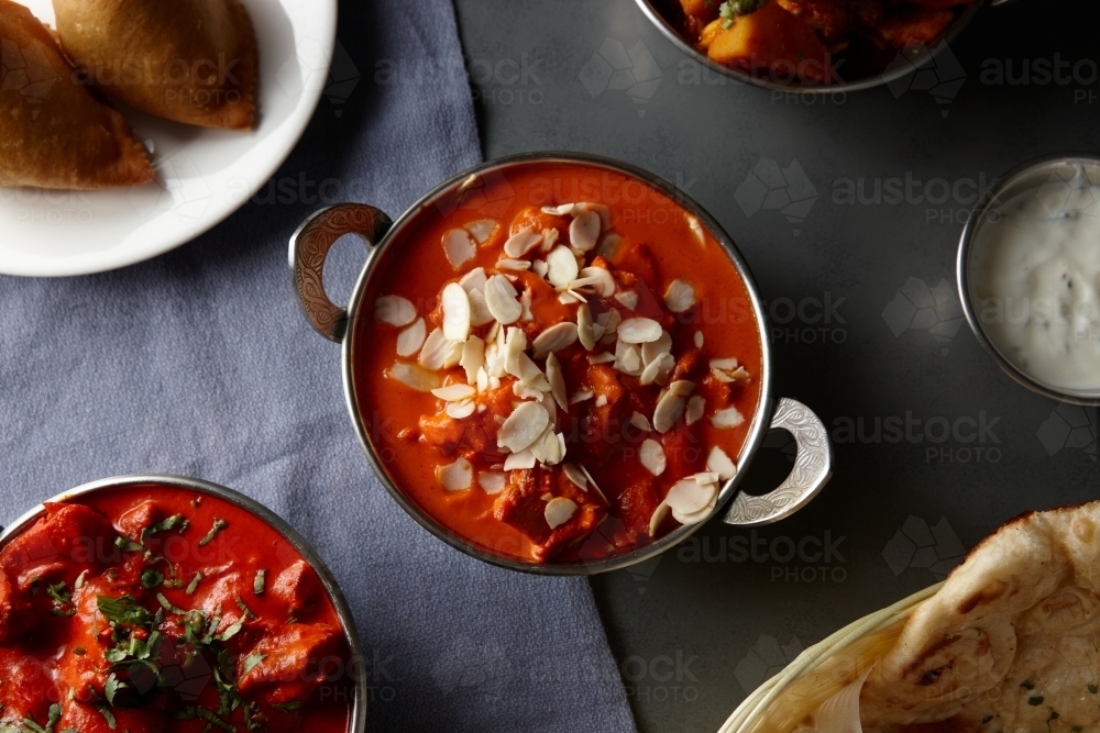 Image of Indian curry dishes on grey table - Austockphoto