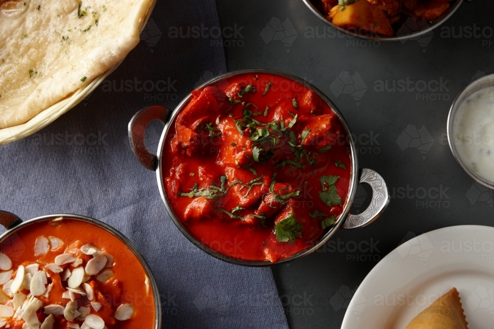 Image of Indian curry dishes on grey table - Austockphoto