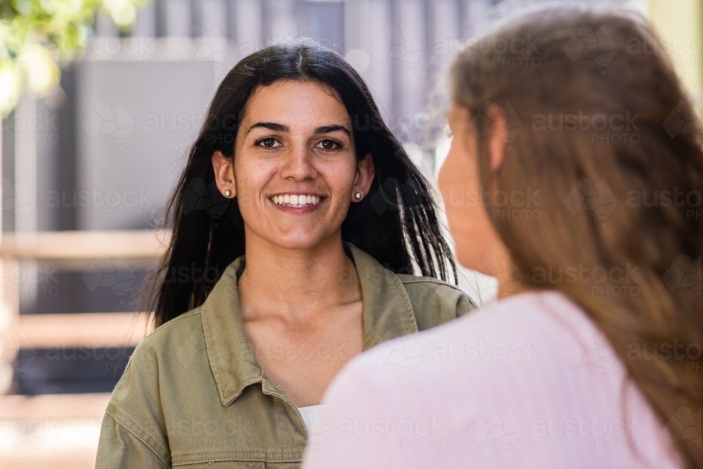 Image of indigenous australian women talking to her friend - Austockphoto