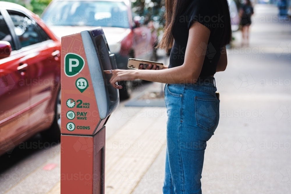 Image of indigenous woman using car parking machine - Austockphoto