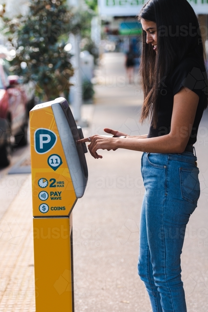 Image of indigenous woman using car parking machine - Austockphoto