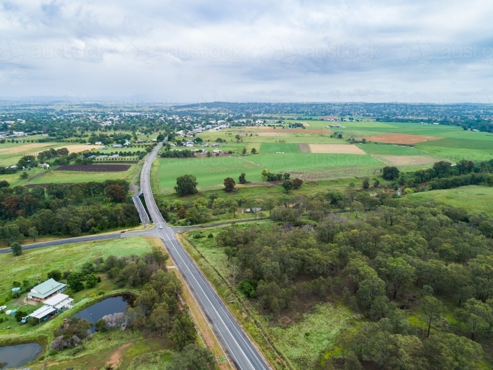 Image of Intersection of country roads going to bridge towards town of ...