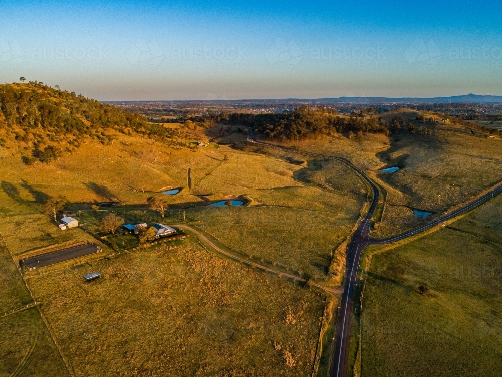 Image of Intersection of country roads in farmland with paddocks bathed ...