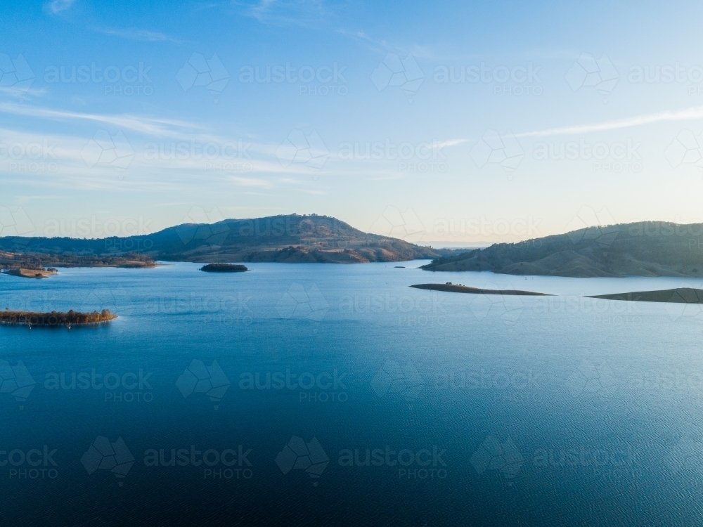 Image of islands in blue lake water from aerial view - Austockphoto