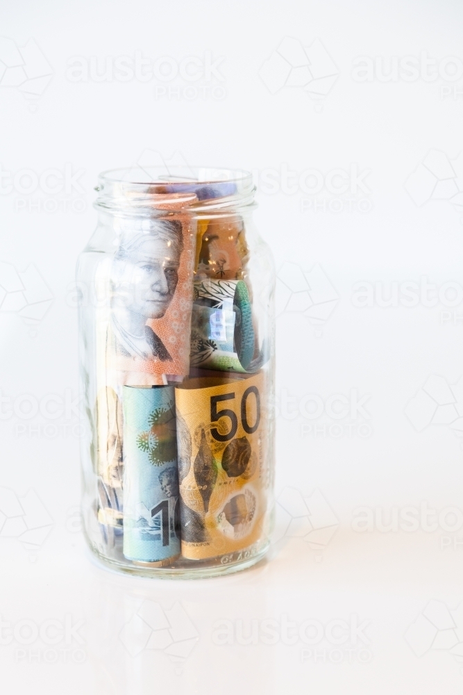 Image of Jar of Australian currency notes and coins - Austockphoto