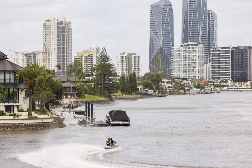 Image of Jetski on the Nerang river with the Gold Coast city skyline in ...
