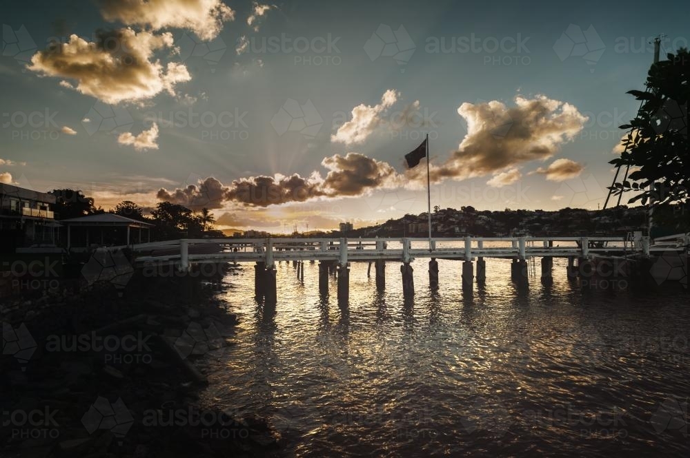 Image of jetty or pontoon over the water at sunset - Austockphoto