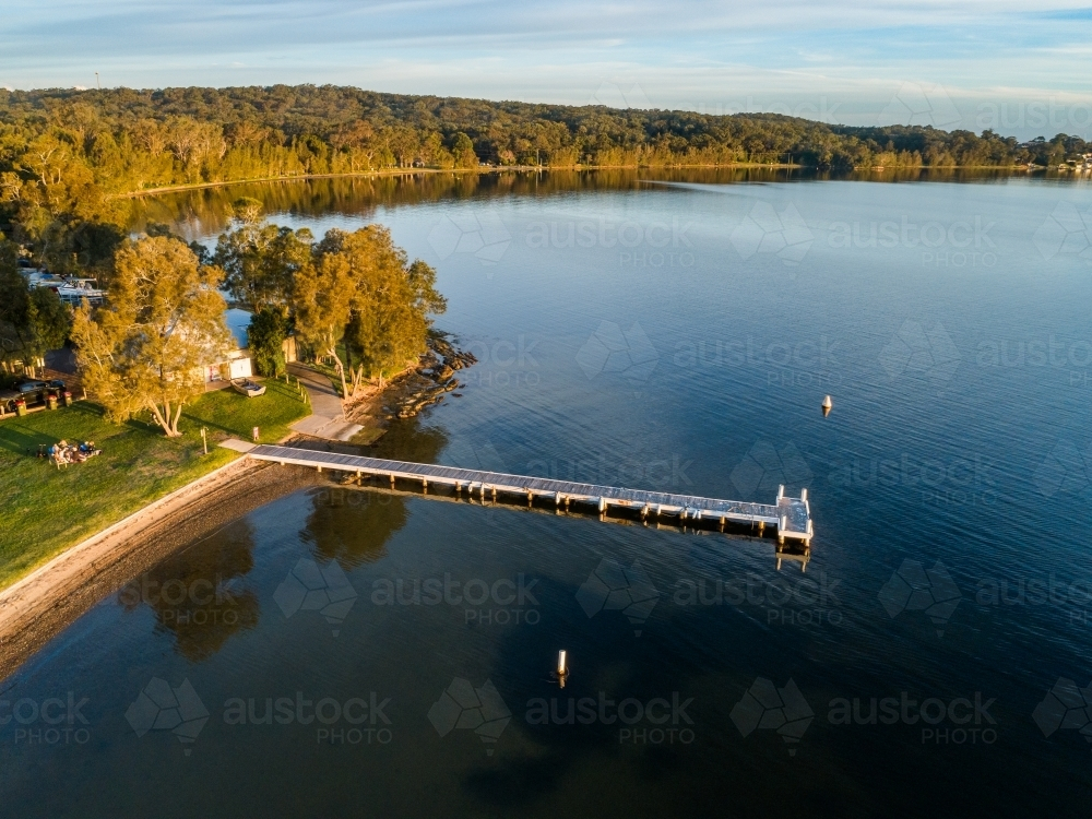 Image of Jetty out in water of Lake in sunset light - Austockphoto