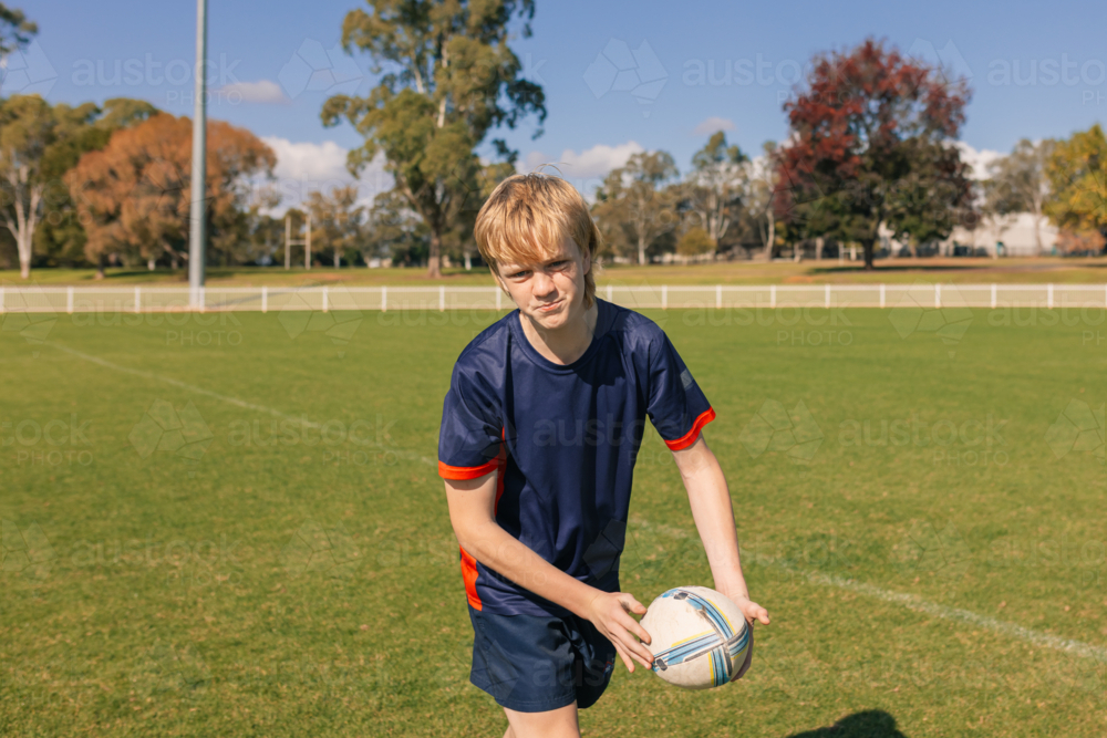Image of Junior rugby union player practicing ball pass on field ...