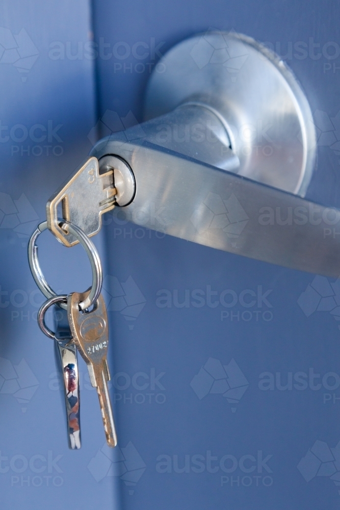 Image of Keys in front door lock keyhole - Austockphoto