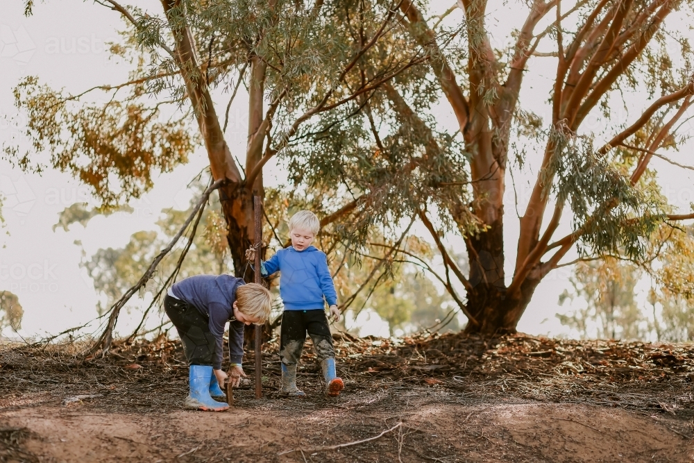 Image of Kids exploring the bush in winter wearing blue gumboots ...