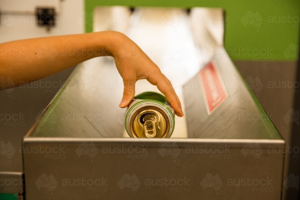 Image of kids helping to recycle empty cans - Austockphoto