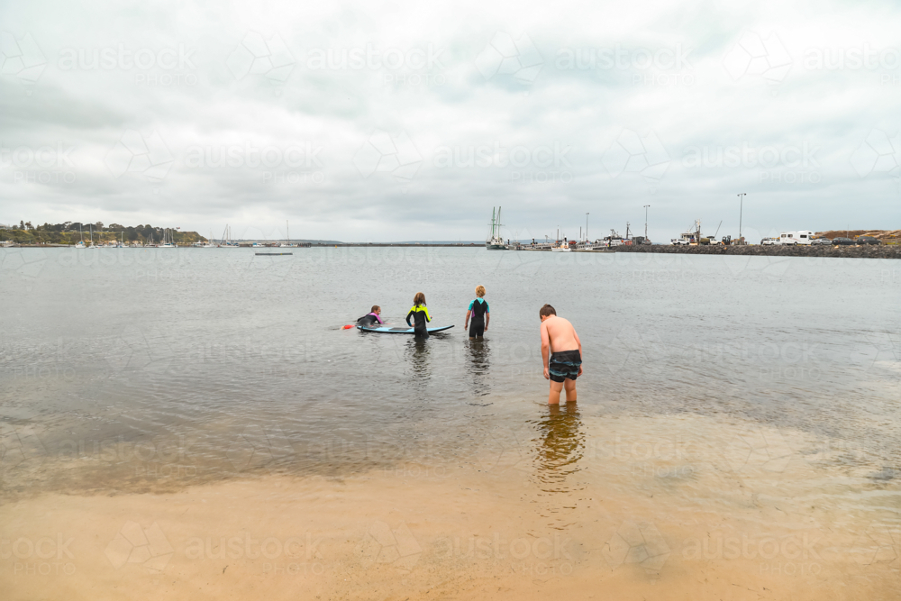 Image of Kids playing in calm water at the beach in Portland, Victoria ...