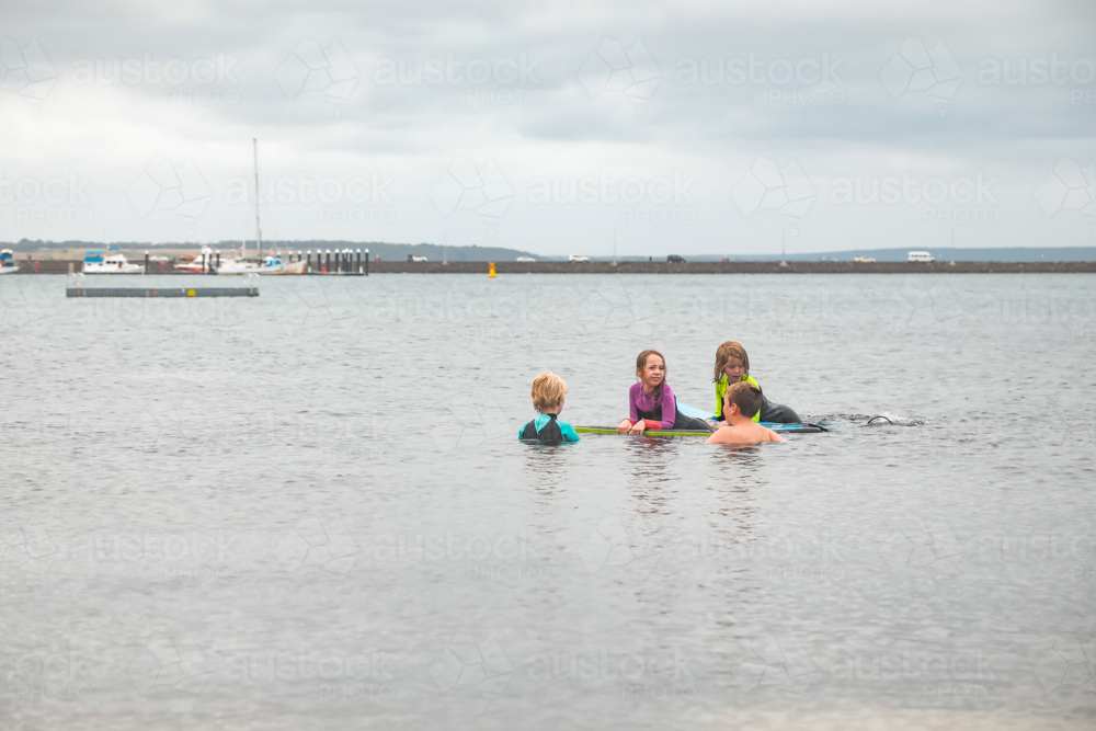 Image of Kids playing in calm water at the beach in Portland, Victoria ...