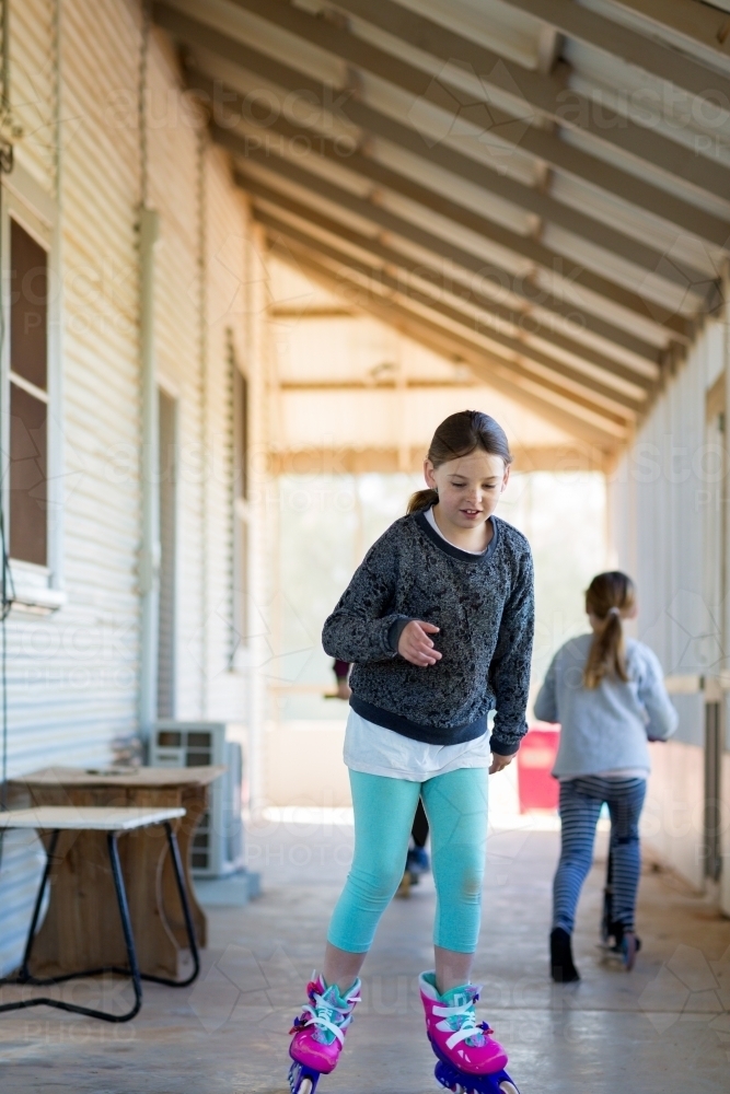 Image of Kids playing on verandah at home - Austockphoto