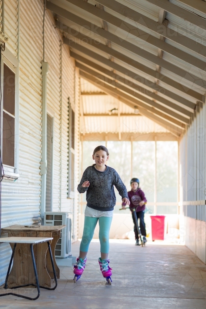 Image of Kids playing on verandah at home - Austockphoto