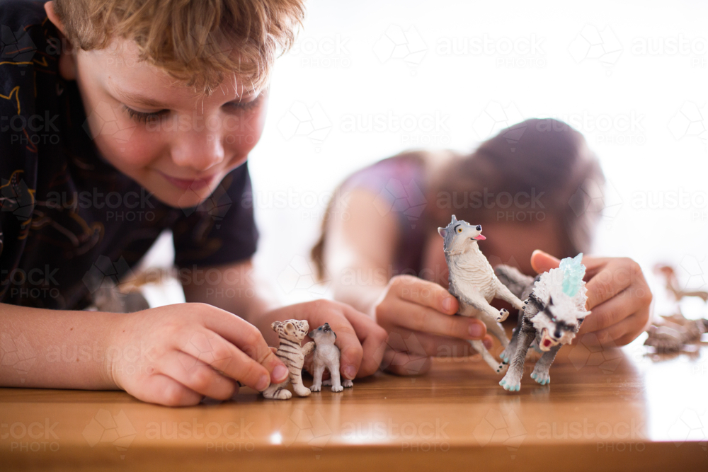 Image of kids playing with plastic toy animals - Austockphoto