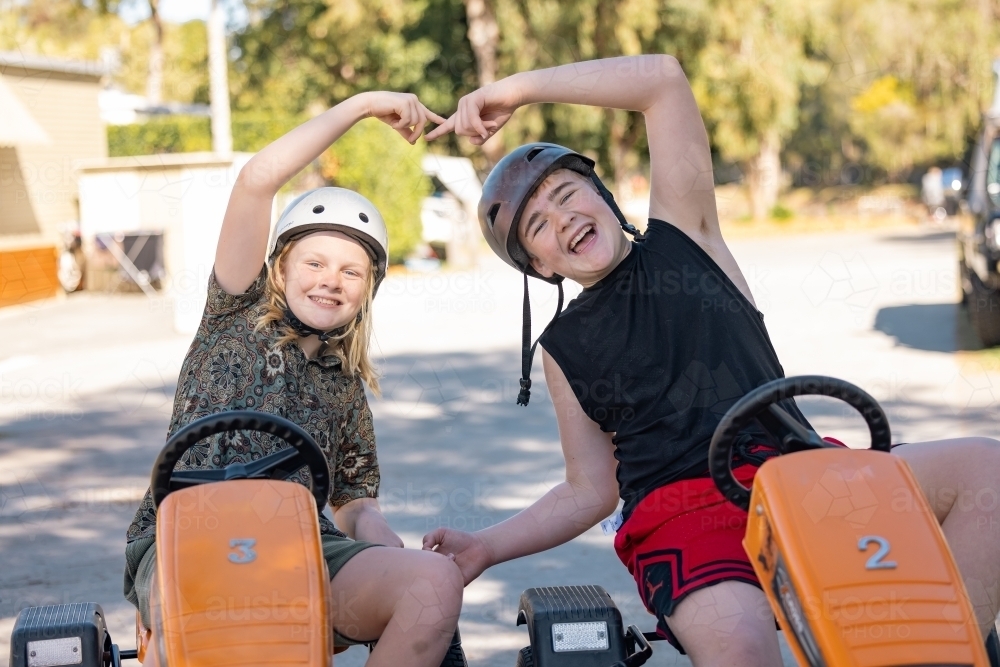 Image of Kids riding pedal carts on family holiday at caravan park ...