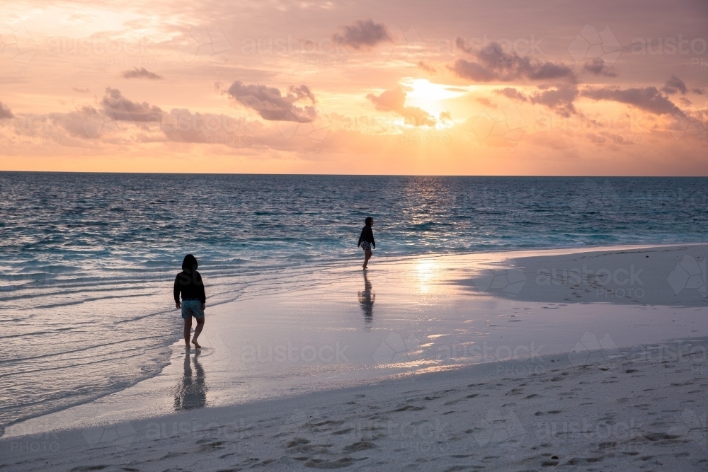 Image of Kids walking on the beach at dawn at Heron Island - Austockphoto