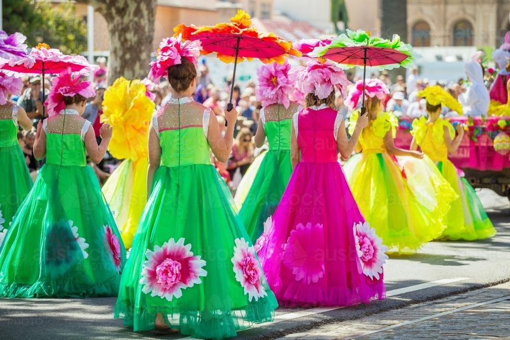 Image of Ladies in colourful dresses in a parade - Austockphoto