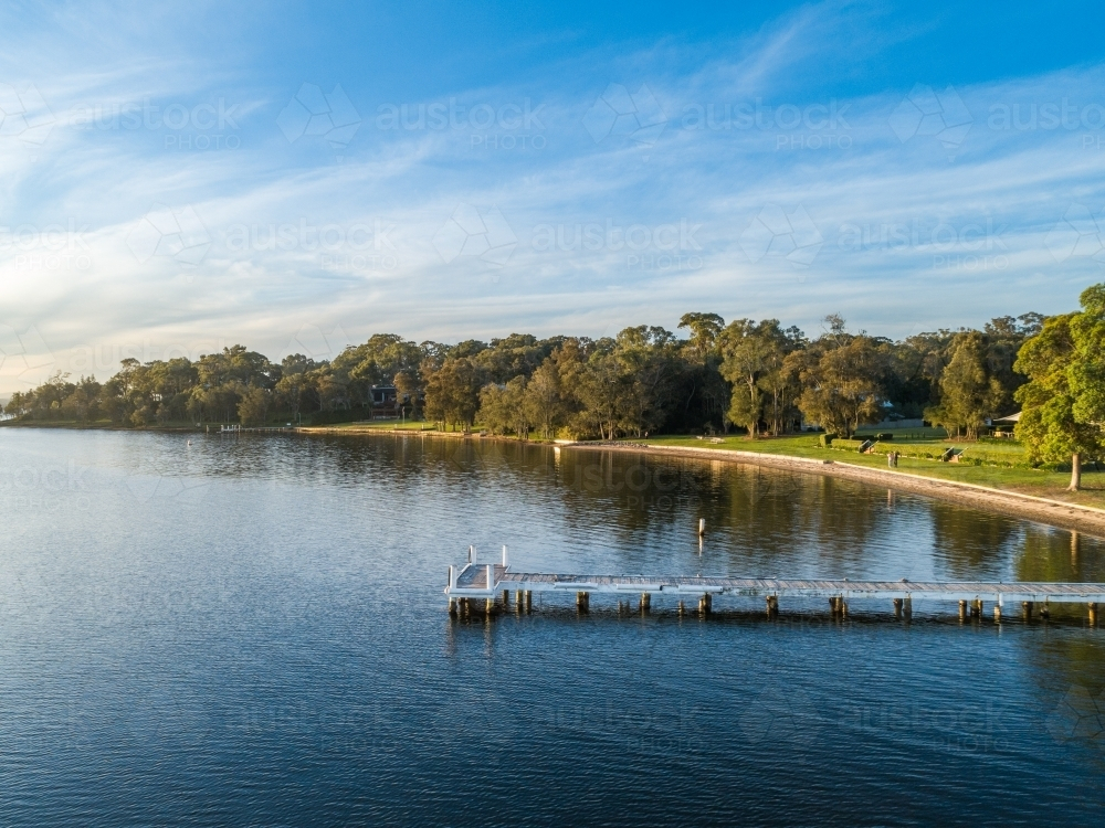 Image of Lakeside jetty in waters of - Austockphoto